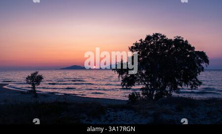 Beach sunset setting behind Kalymnos island from Kos island, Greece ...