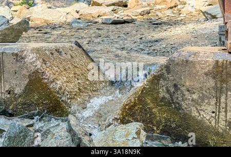 V-notch weir cut into a concrete retaining wall for water restriction ...