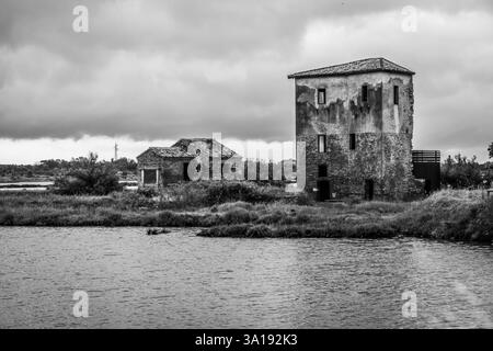 Abandoned building in front of a lagoon. Creepy construction exterior ...