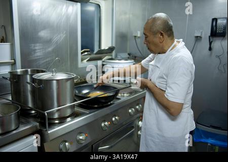 Galley kitchen of Container Ship with Crew Chef smiling preparing meal ...