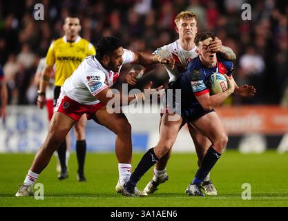 St Helens' George Delaney (right) is tackled by Leigh Leopards' Matt ...
