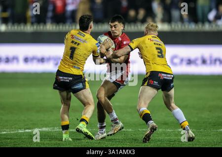 Zac Cini of Castleford Tigers is tackled by Arron Lindop of Warrington ...