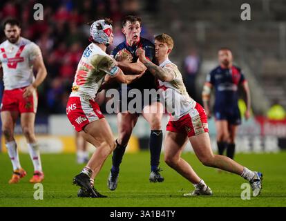 St Helens' George Delaney (left) is tackled by Leigh Leopards' Edwin ...
