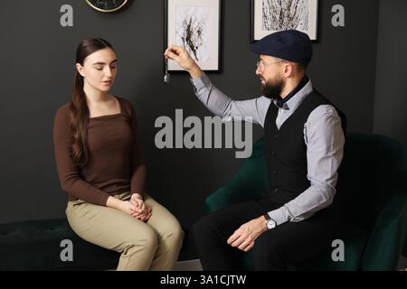 Psychologist using vintage pocket watch while working with patient ...