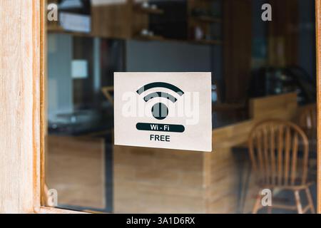 free Wi-Fi sign is posted on the glass door in front of the restaurant ...
