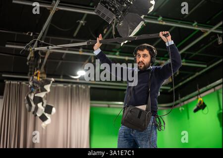 Boom microphone operator testing sound at TV studio. High quality ...