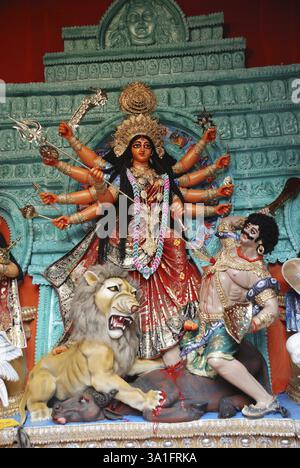 Durga clay model killing demon mahishasura with statues of kartikeya ...