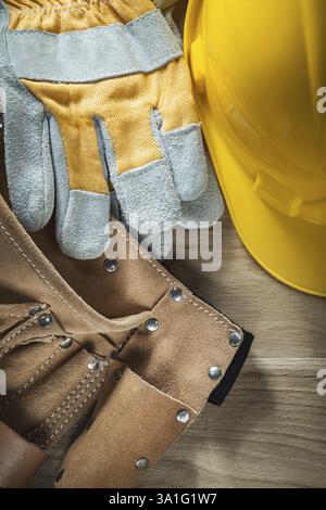 Leather tool belt protective gloves on concrete background Stock Photo ...
