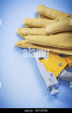 Leather safety gloves construction stapler on wooden board Stock Photo ...