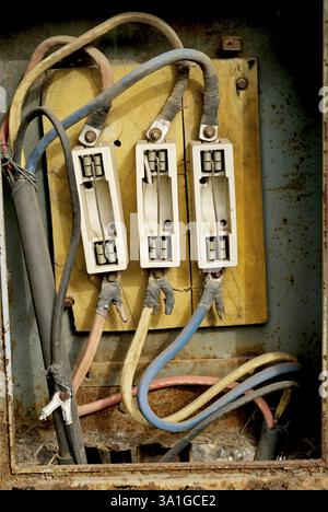 A open empty electricity fuse box with cables on white wall. Electrical ...