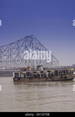 view at Howrah bridge with ferry at Hooghly river in Calcutta, India ...