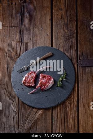 Lamb ribs cooking. Raw rack of lamb meat set, on white stone table ...