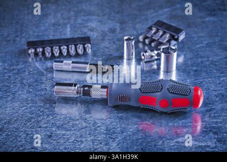 Insulated screwdriver with interchangeable bits and heads on scratched ...