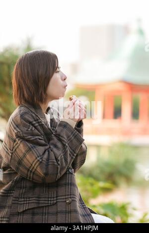 Portrait of young asian woman cover one side of face, looking with one ...