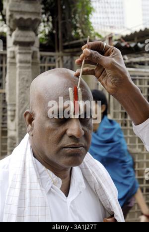 Applying vishnu symbol on the forehead of Lord Balaji Devotee, Tirumala ...
