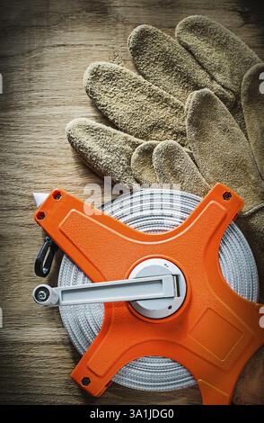 Leather protective gloves measuring tape on corrugated metal sheet ...