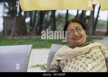 woman resting at Vayangani beach at Sindhudurgh ; Maharashtra ; India ...