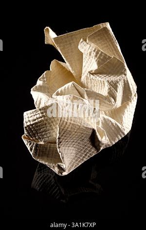 Crumpled paper, paper sculpture fine art on black background Stock ...