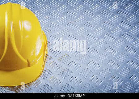 Protective building helmet on chequered metal sheet copy space ...