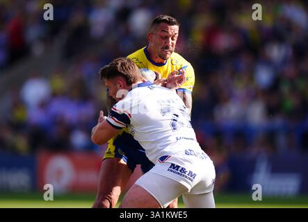 Warrington Wolves' Paul Vaughan is tackled during the Challenge Cup ...