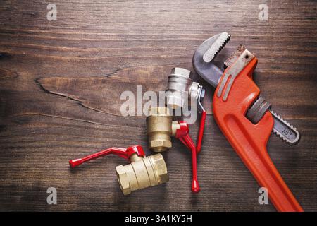 organized copyspace two plumbers fixtures and monkey wrench on vintage ...
