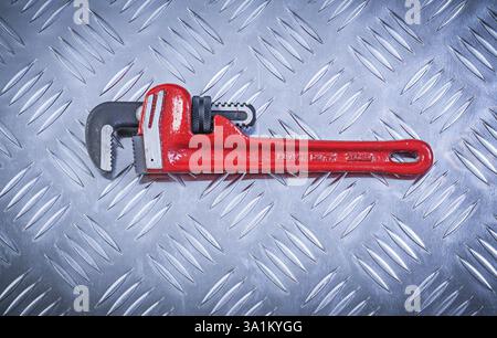 Pipe wrench on fluted metal plate construction concept Stock Photo - Alamy