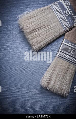 Paintbrushes on wooden board vertical version construction concept ...