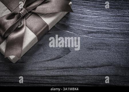 Present box wrapped in recycled paper on wooden board Stock Photo - Alamy