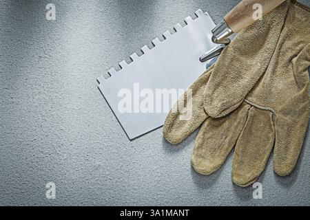 Leather protective gloves on concrete surface construction concept ...