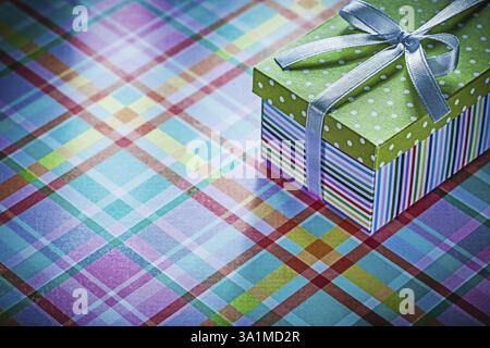 Present in cardboard box on striped background holidays concept Stock ...
