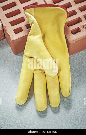 Leather protective gloves on concrete surface construction concept ...