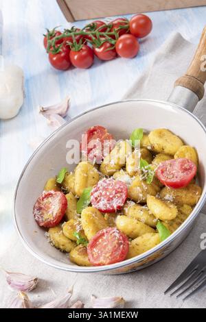 GNAcchi gebacken mit gruenem pesto, kirsch tomaten und parmesan Stock ...