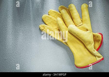 Leather protective gloves on concrete surface construction concept ...