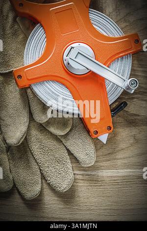 Leather protective gloves measuring tape on wooden board Stock Photo ...