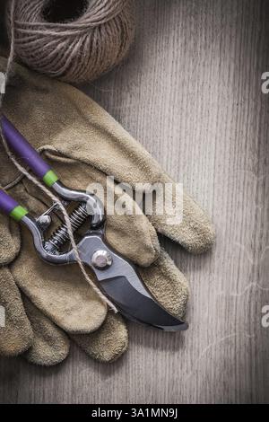 Pair of leather brown protective gloves on scratched metallic ...