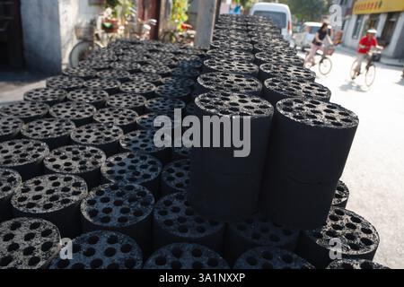 East Asian coal briquettes stacked on a cart - Tianjin, China Stock ...