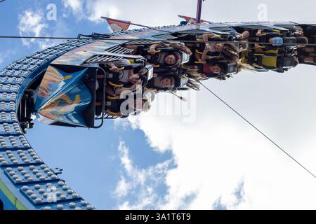 Riders experience thrills on an upside-down midway amusement ride Stock ...