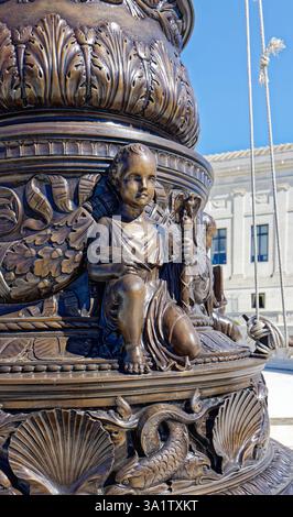 Detail: Bronze base of flagpole showing cherub holding sword ...