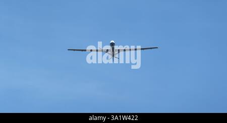 General Atomics MQ-9 Reaper drone flying over the mountains at sunset ...