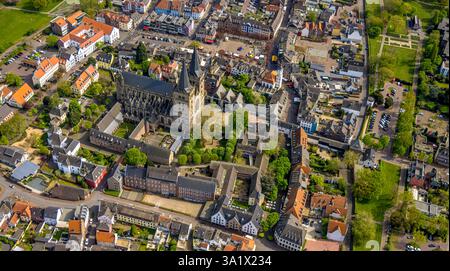 An aerial top view of the roads meeting in a round square with green ...