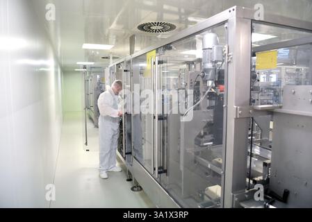 medical products manufacturing in a modern factory - worker operates ...