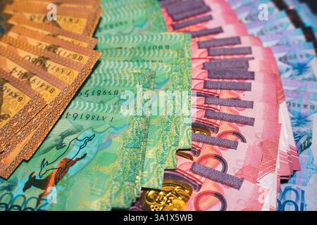Tenge banknotes of different denominations laid out in a cross. Paper ...