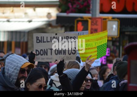 Anti-Elon Musk signs at an International Women's Day march in New York ...