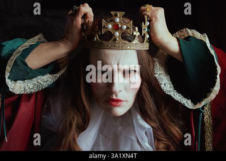 scary medieval queen in red dress with white collar on dark gray ...