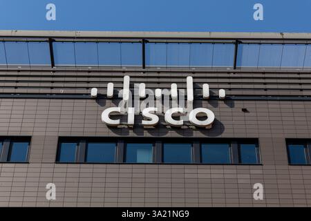 Cisco logo on outdoor sign surrounded by landscaping on a sunny day ...