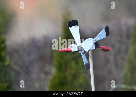 Wooden stork flapping its wings in strong wind decorative ornament ...