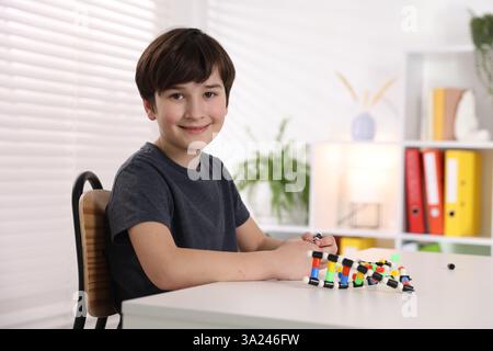 Boy making DNA structure model at desk indoors Stock Photo - Alamy