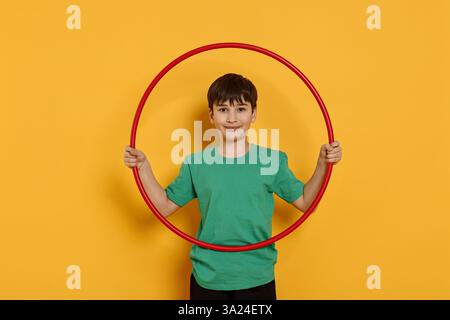 Boy with hula hoop on yellow background Stock Photo - Alamy