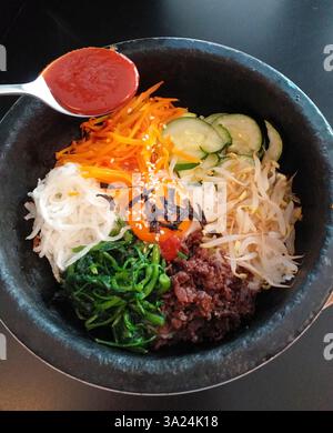 Traditional Korean dish- Bibimbap, rice with egg, beef and vegetables ...