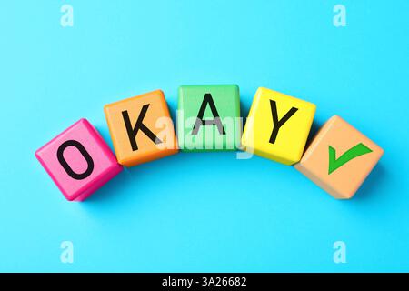 Colorful cubes with word Okay and check mark on color background Stock ...